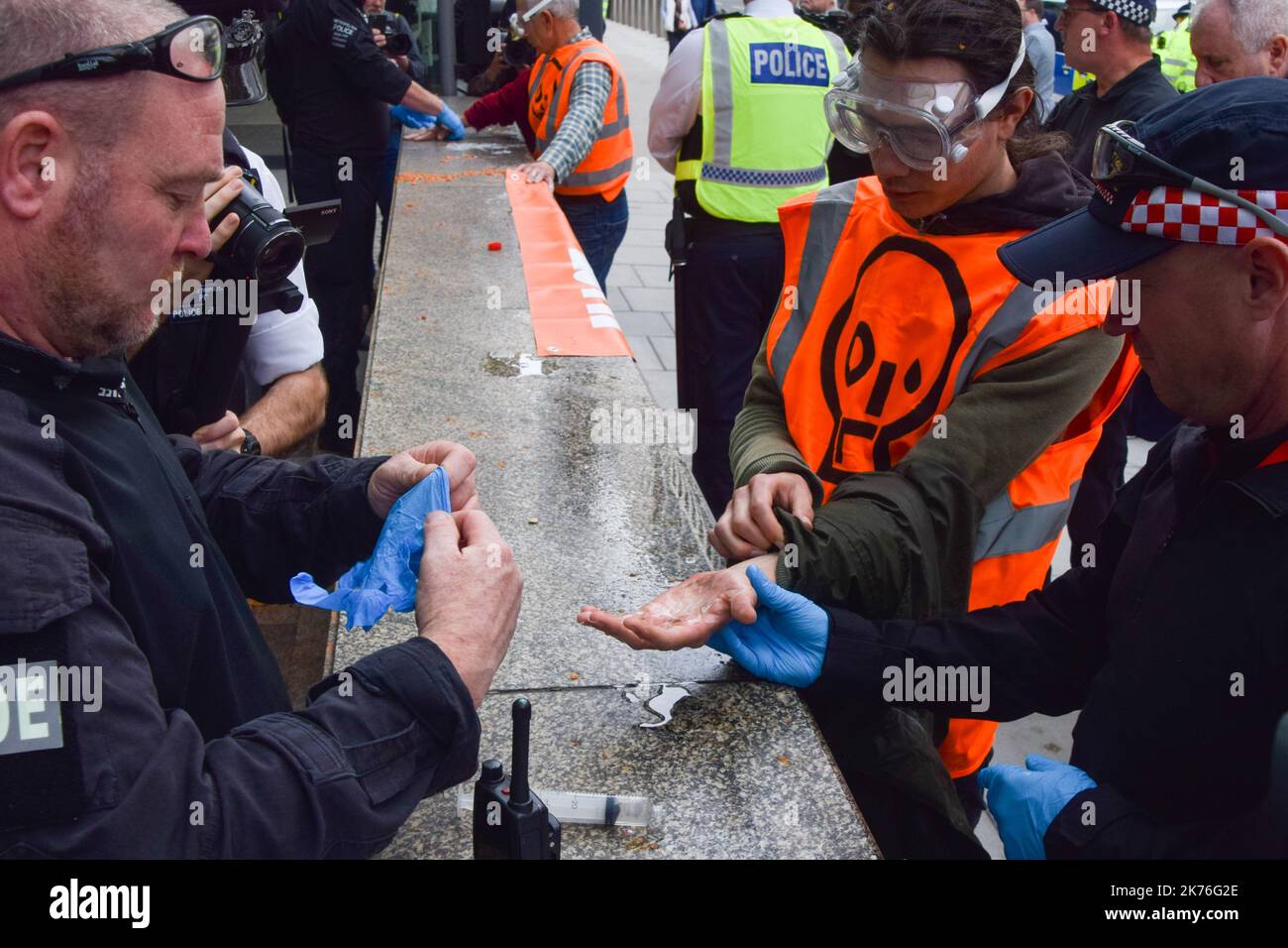 London, UK. 17th October 2022. Police officers dissolve the superglue ...