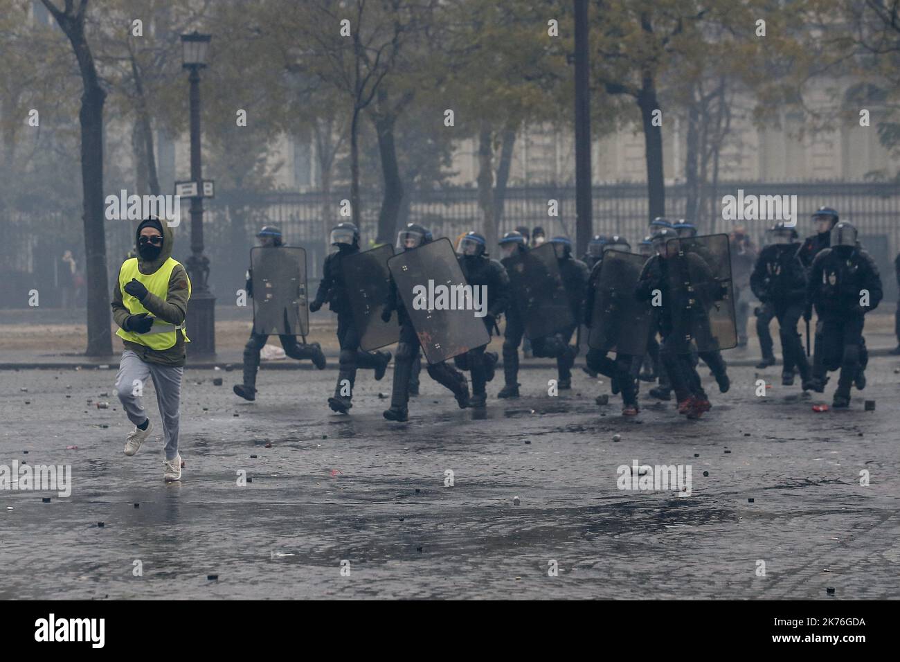 Demonstrator runs during clashes with police riot as part of a protest ...