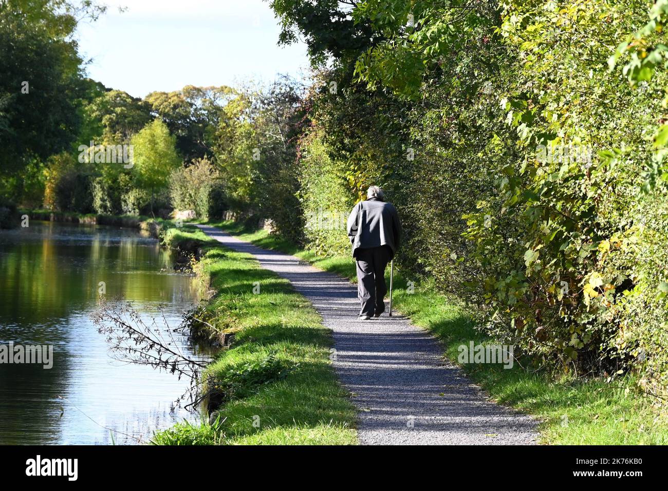 An elderly man walks on the tow path by the Peak Forest Canal in New ...