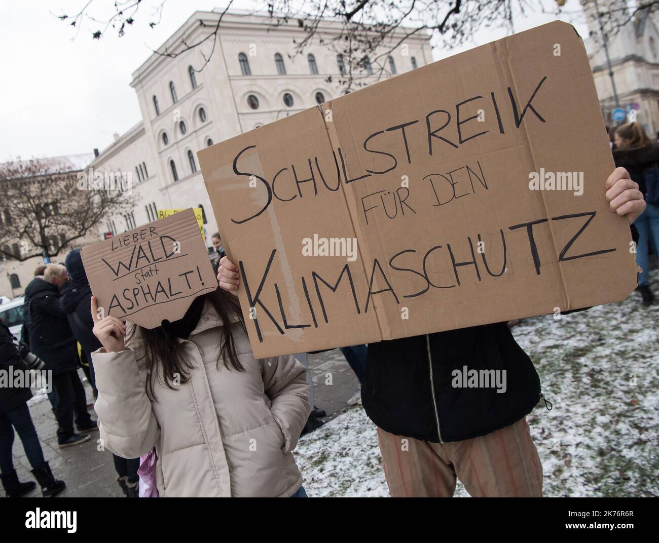 Students demonstrate with self-painted posters in front of the ...