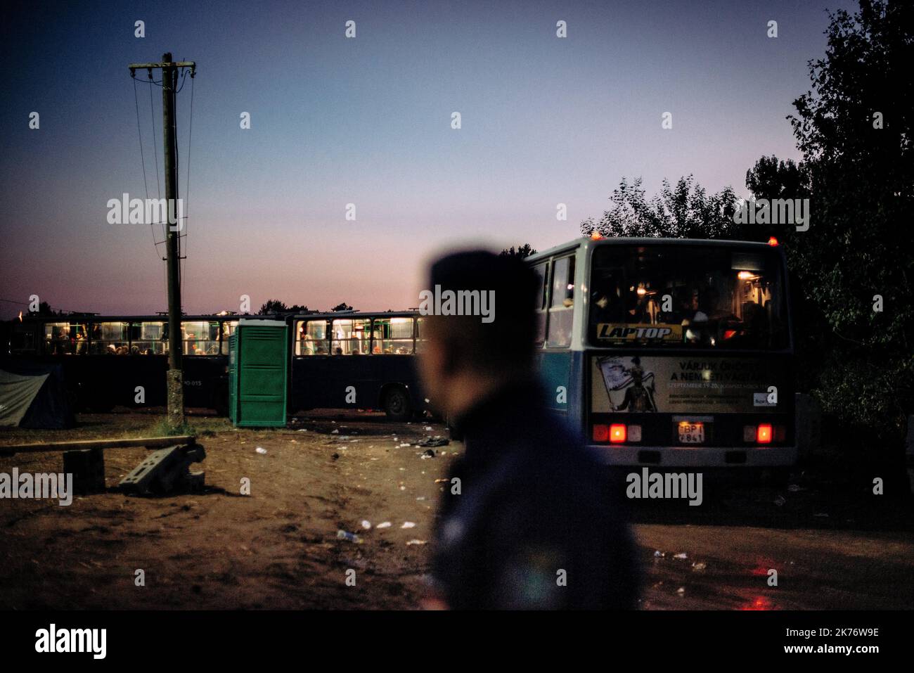 Refugee buses arrive at a police-guarded camp in Roszke, the Serbian ...