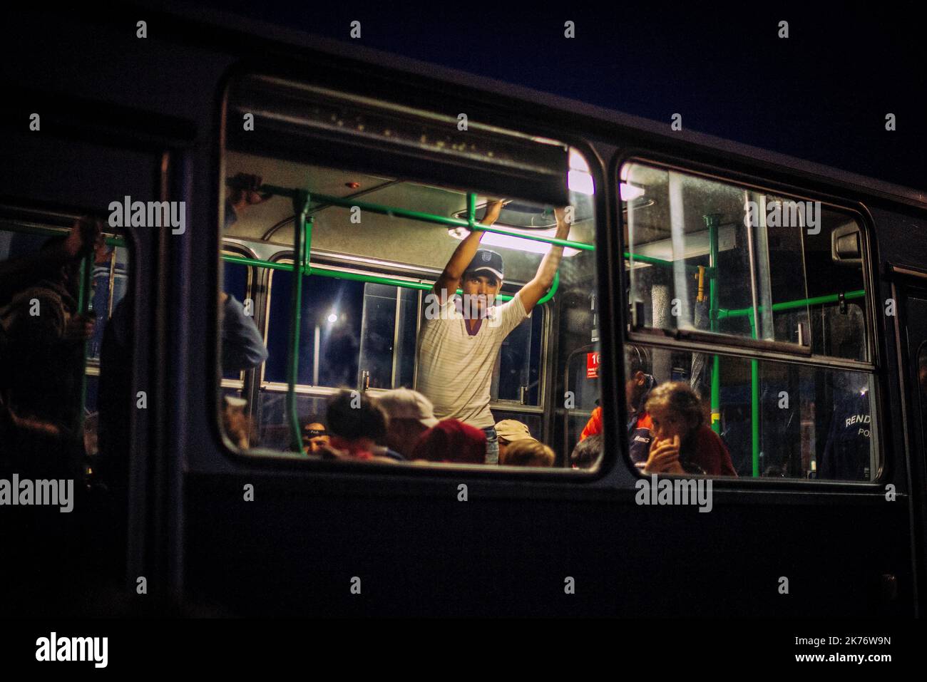 Refugee waits on a bus at the entrance to a camp in Roszke, the Serbian ...