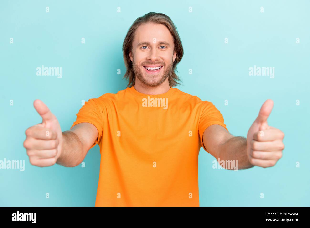Photo of confident funny man wear orange t-shirt smiling showing two ...