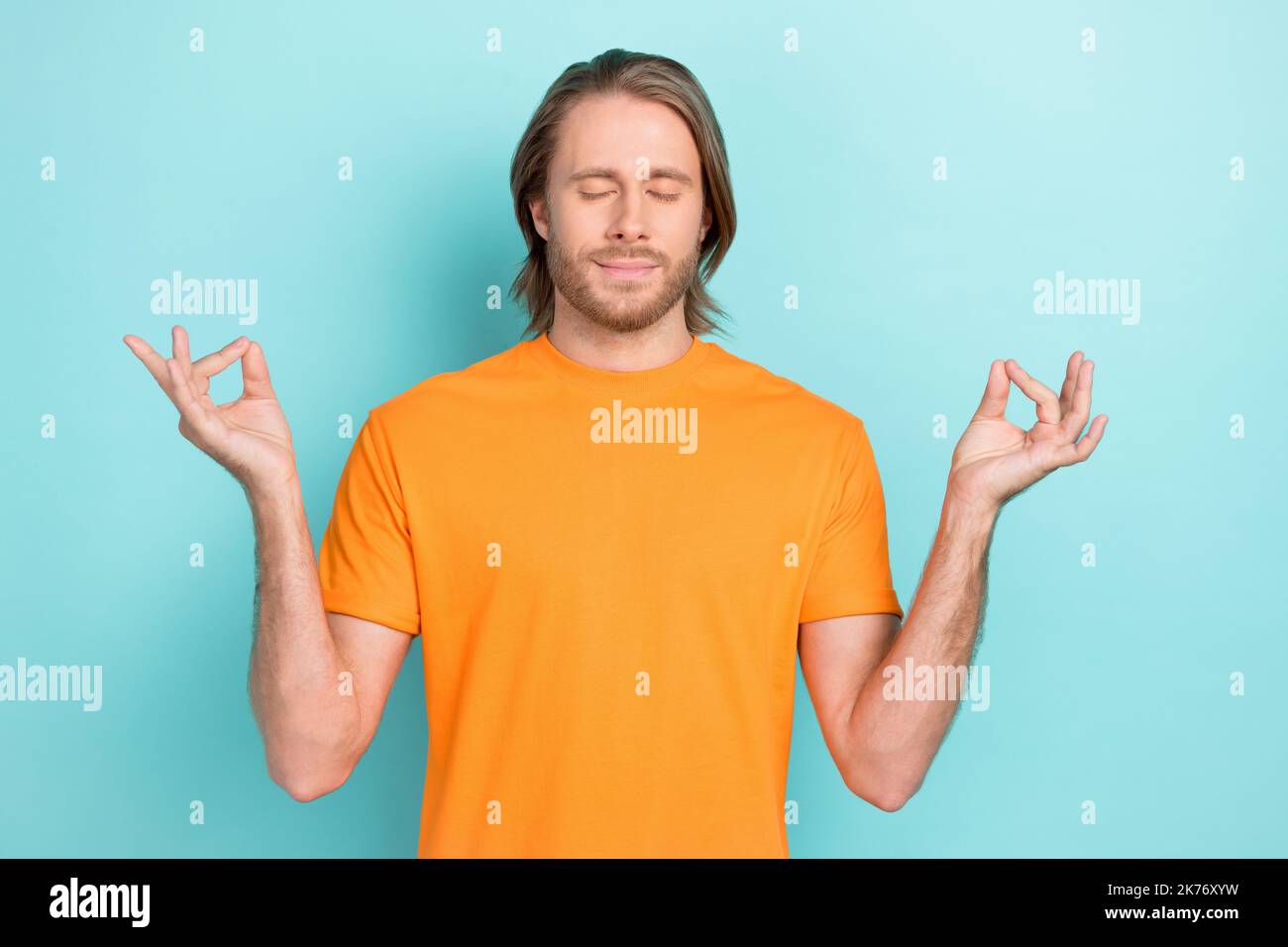 Photo of dreamy sweet man wear orange t-shirt practicing yoga smiling ...