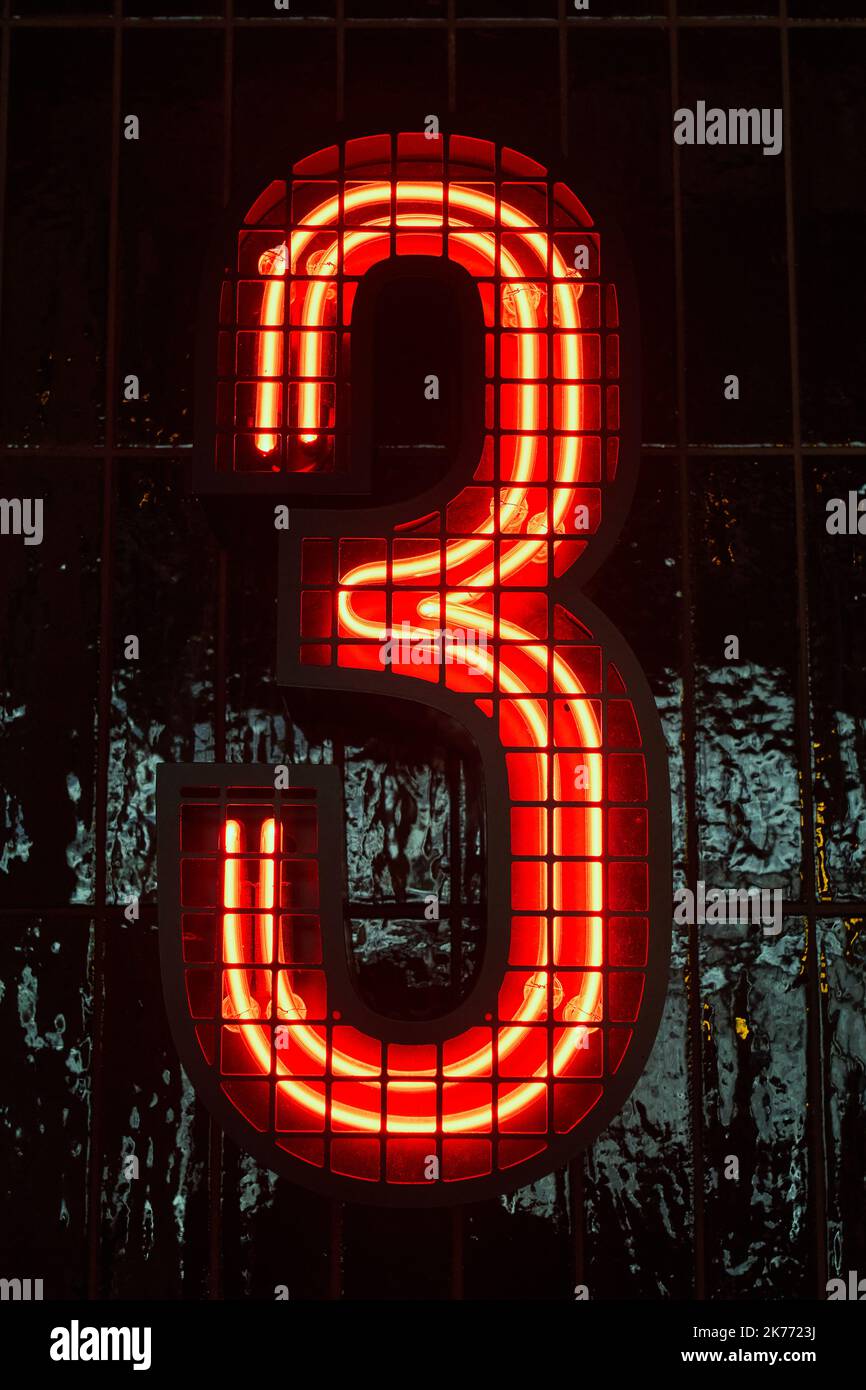 Large neon three Stock Photo - Alamy