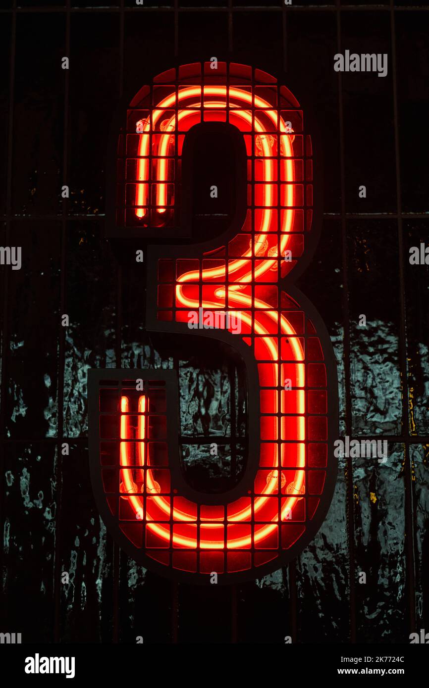 Large neon three Stock Photo - Alamy