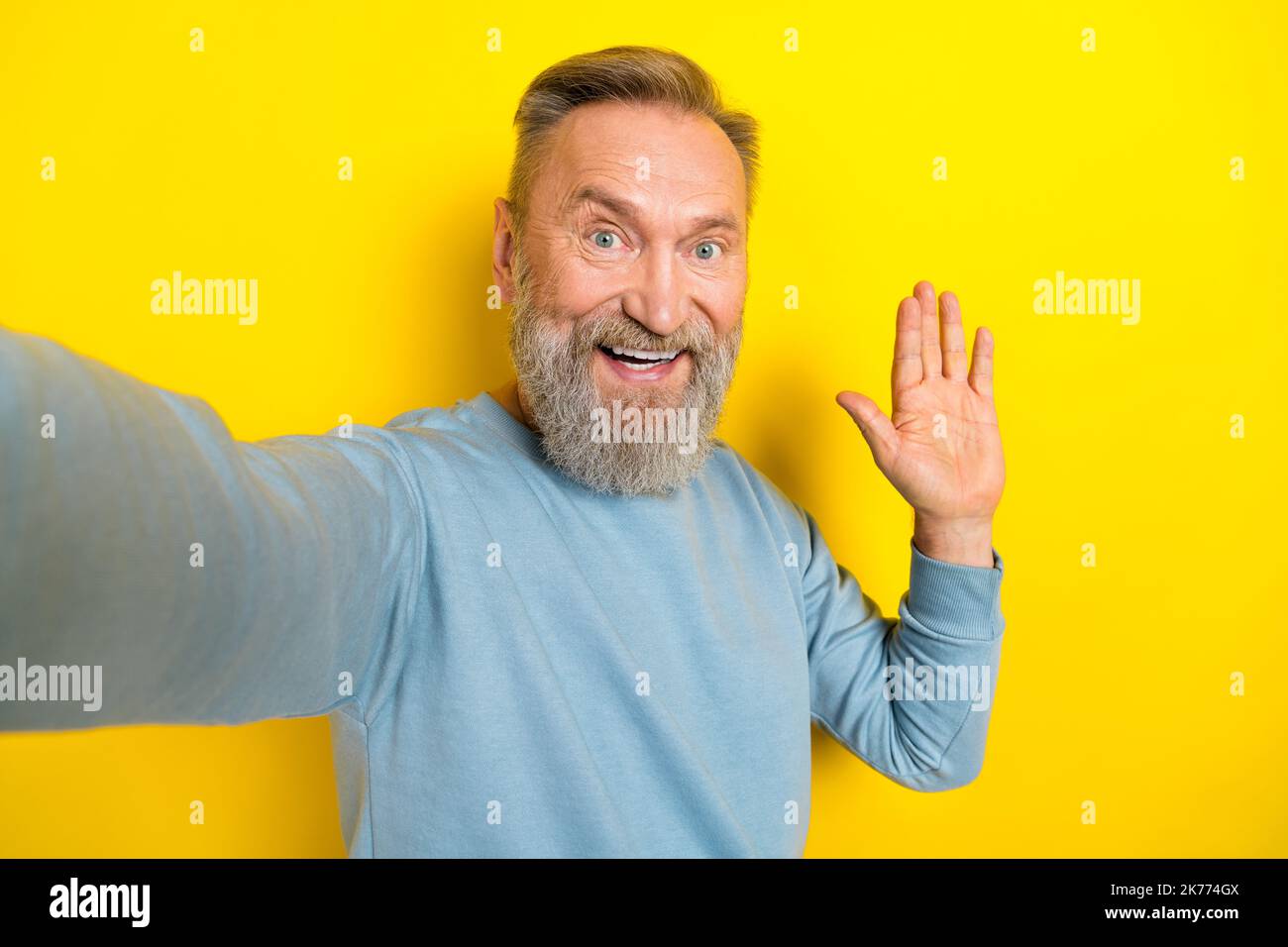 Photo of attractive friendly retired guy wear blue sweater tacking ...