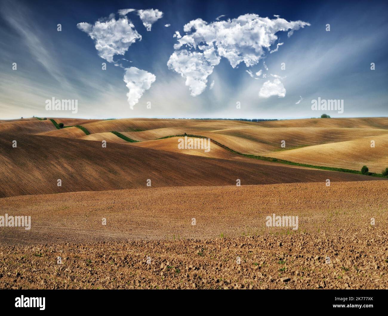 clouds in the form of a map of the world over the field. Travel and ...