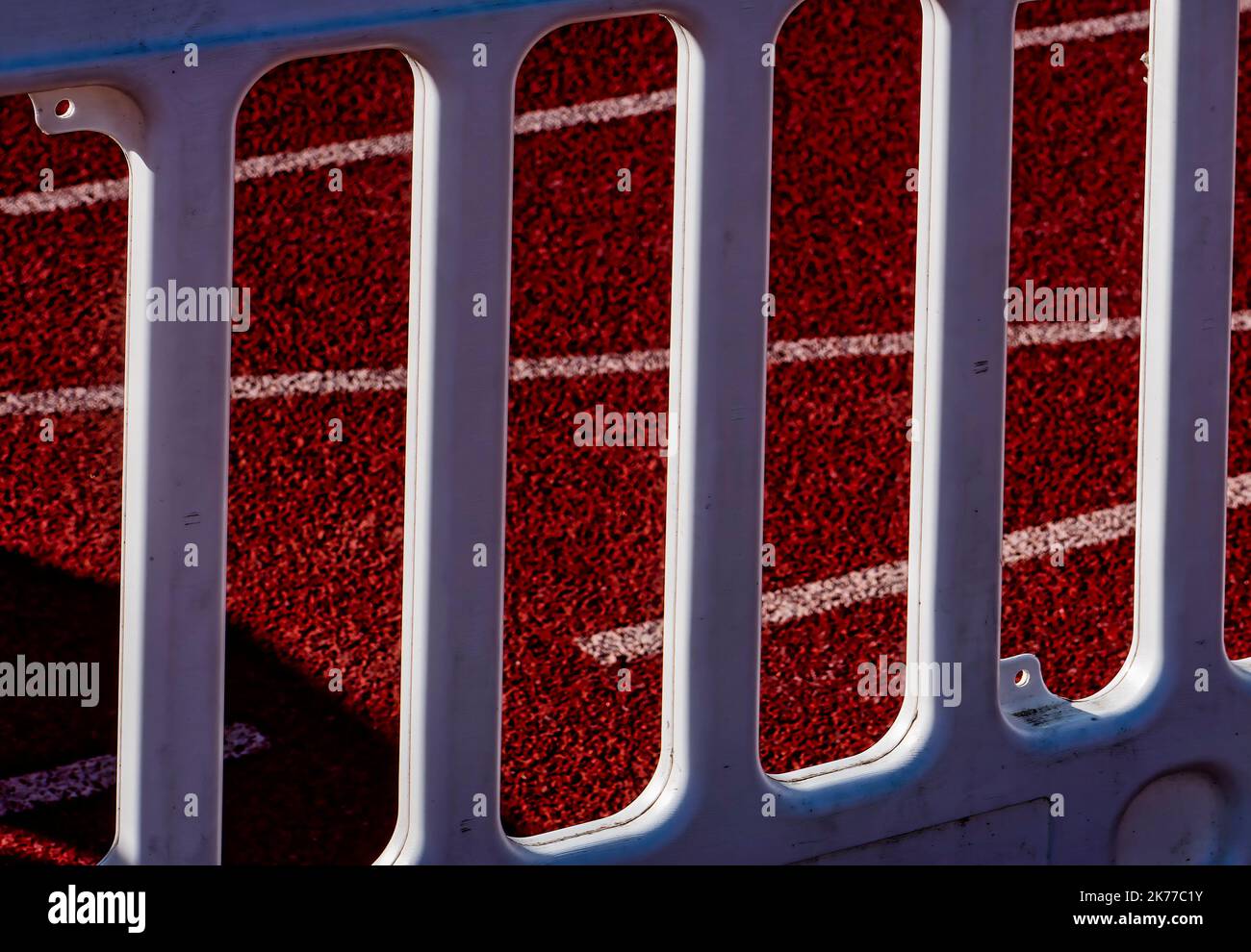Stadium running track seen through a fence Stock Photo - Alamy