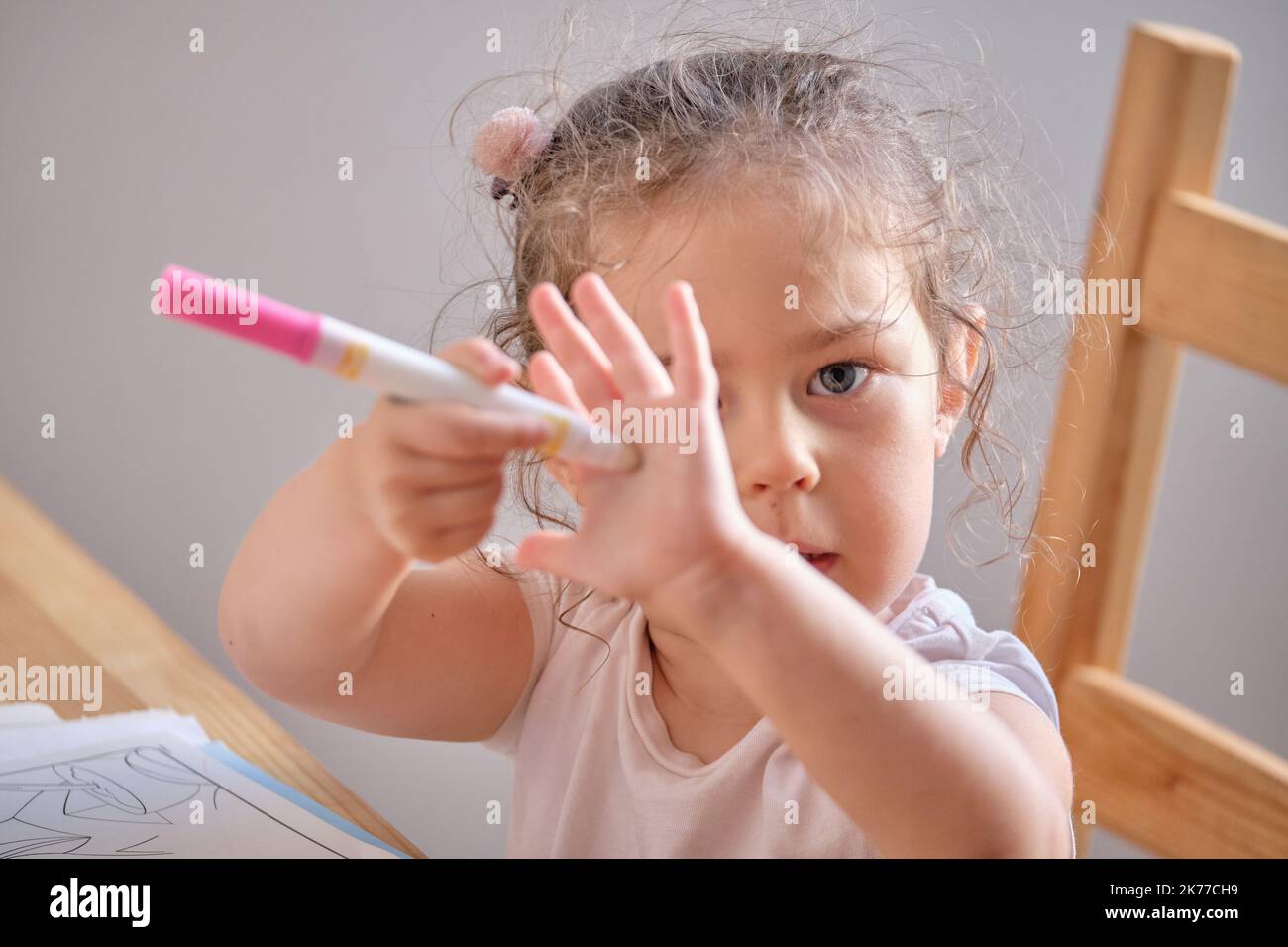 Little girl playing iwth invisible ink and coloring book Stock Photo ...
