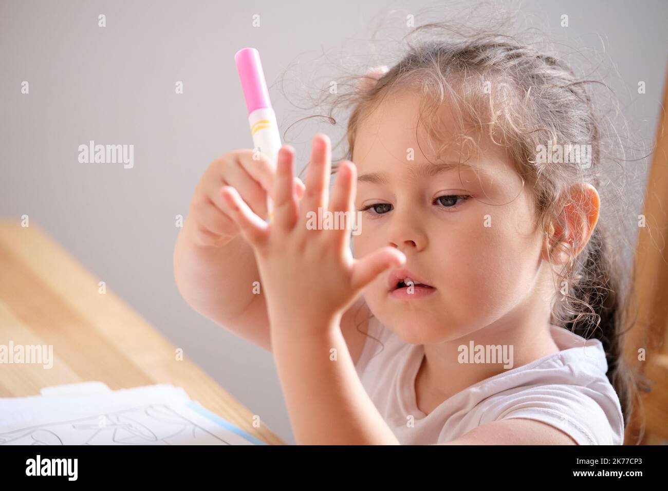 Little girl playing iwth invisible ink and coloring book Stock Photo ...