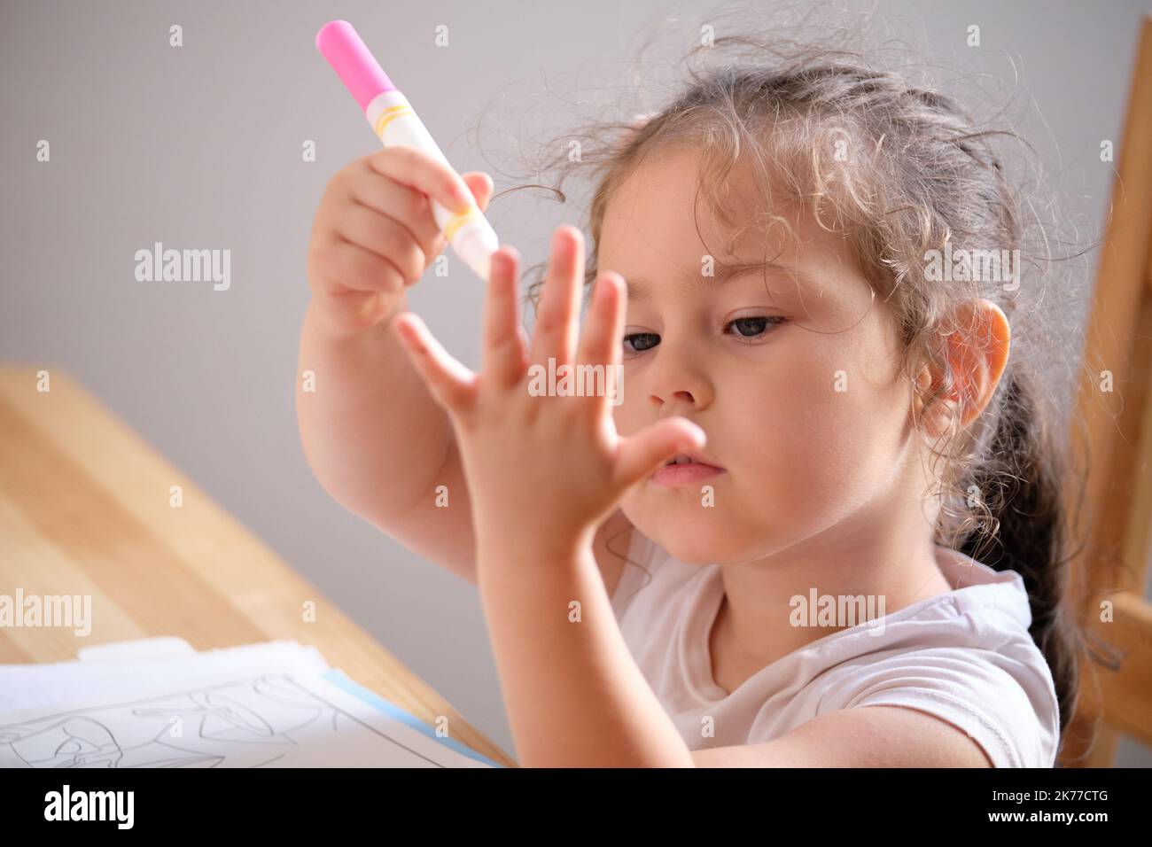 Little girl playing iwth invisible ink and coloring book Stock Photo ...