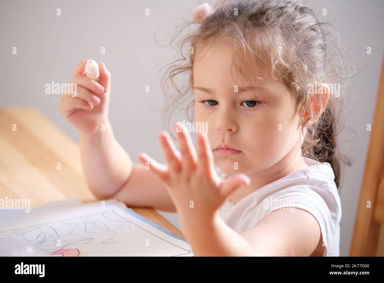 Little girl playing iwth invisible ink and coloring book Stock Photo ...