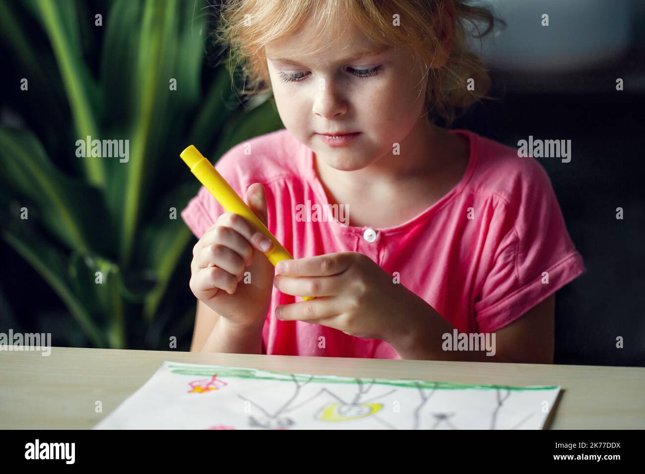 Little girl drawing a picture with colored markers. Child, sitting at ...