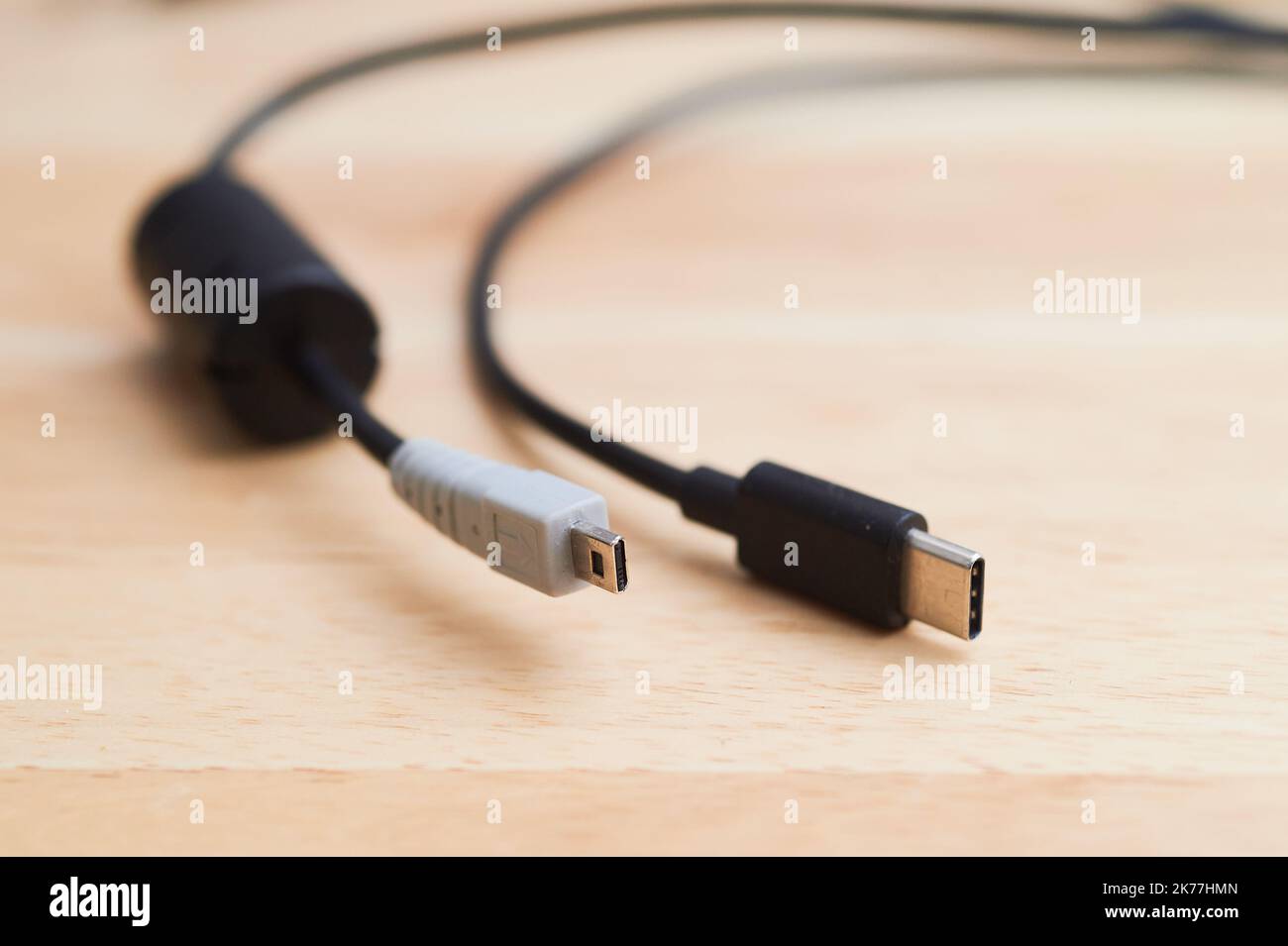 several charging cables lying on a table, including USB A 2.0 and USB C ...