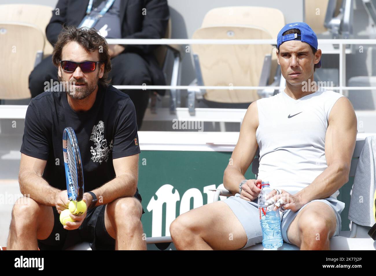 Rafael Nadal of Spain and his coach Carlos Moya speak during a training ...