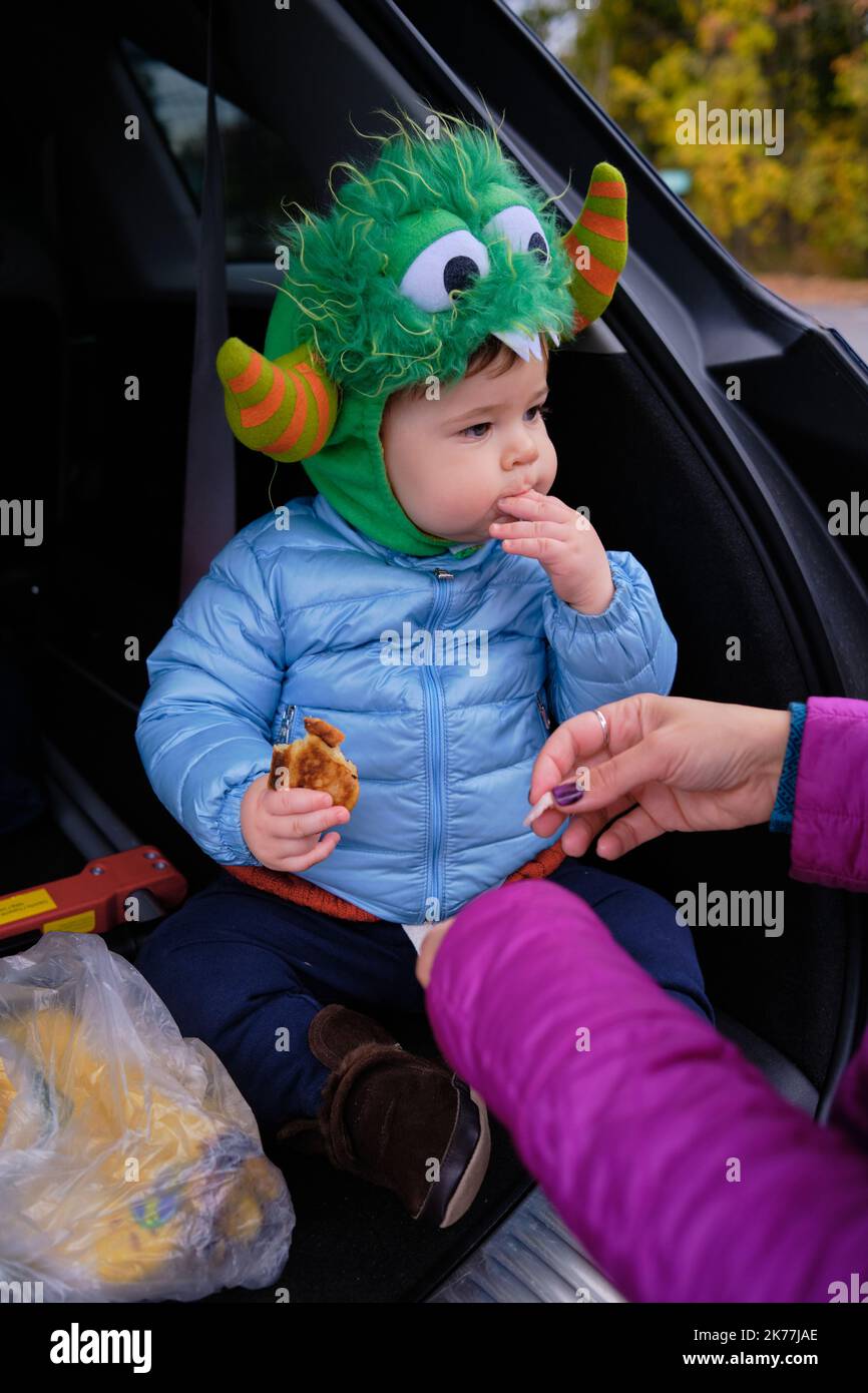 Tailgating baby monster is having some snacks in the back of the car on ...
