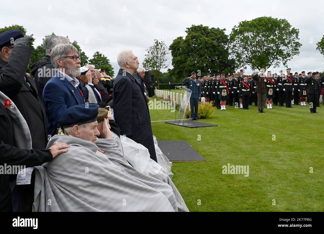Soldiers and Veterans pay their respects during a service to mark the ...