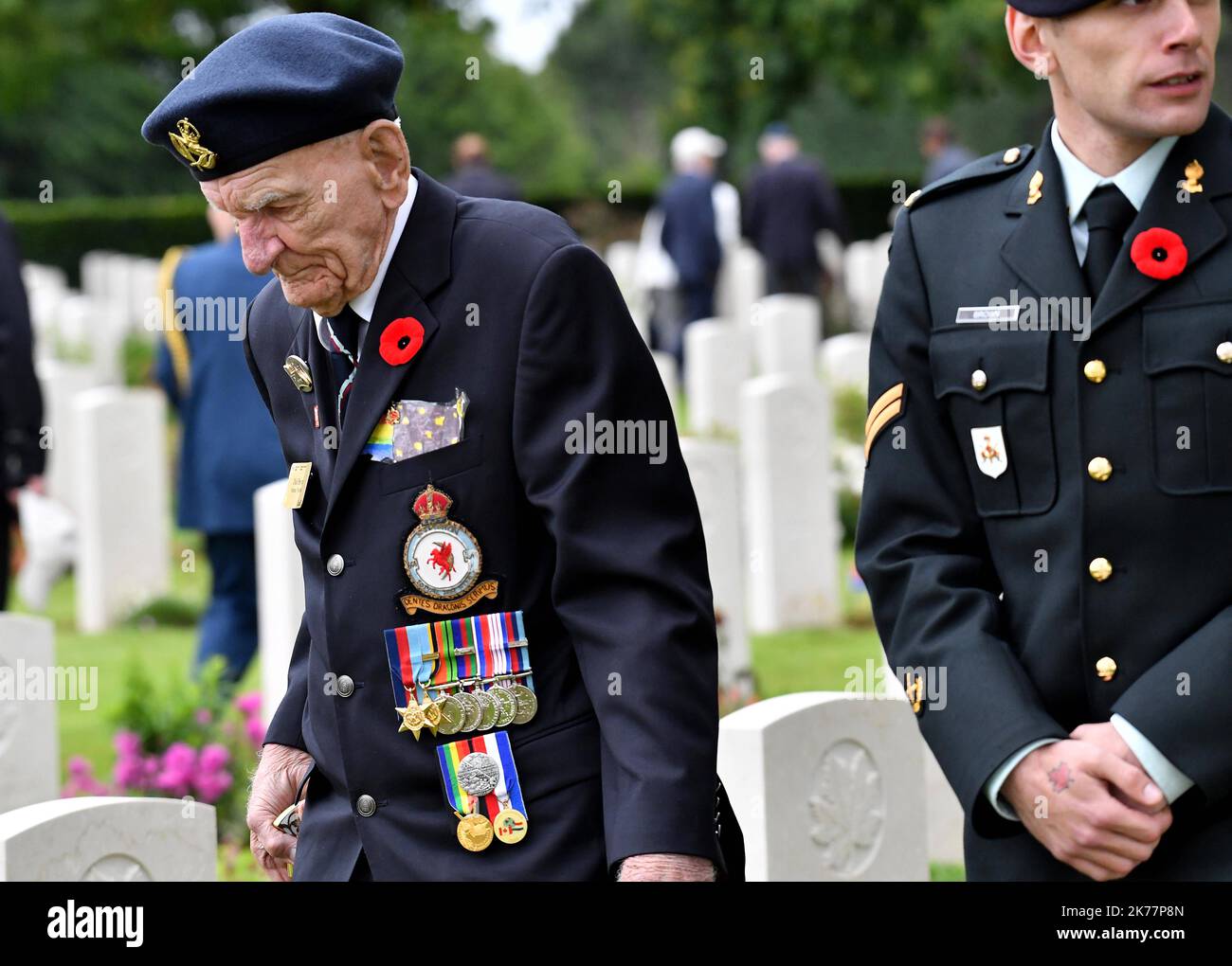 Soldiers and Veterans pay their respects during a service to mark the ...