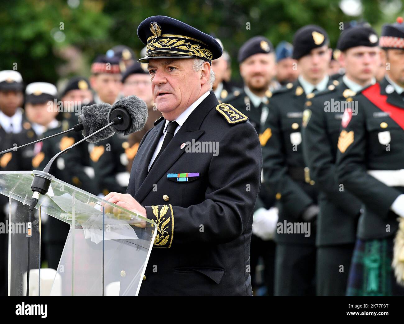 Soldiers and Veterans pay their respects during a service to mark the ...