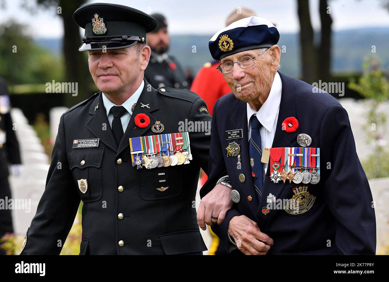 Soldiers and Veterans pay their respects during a service to mark the ...