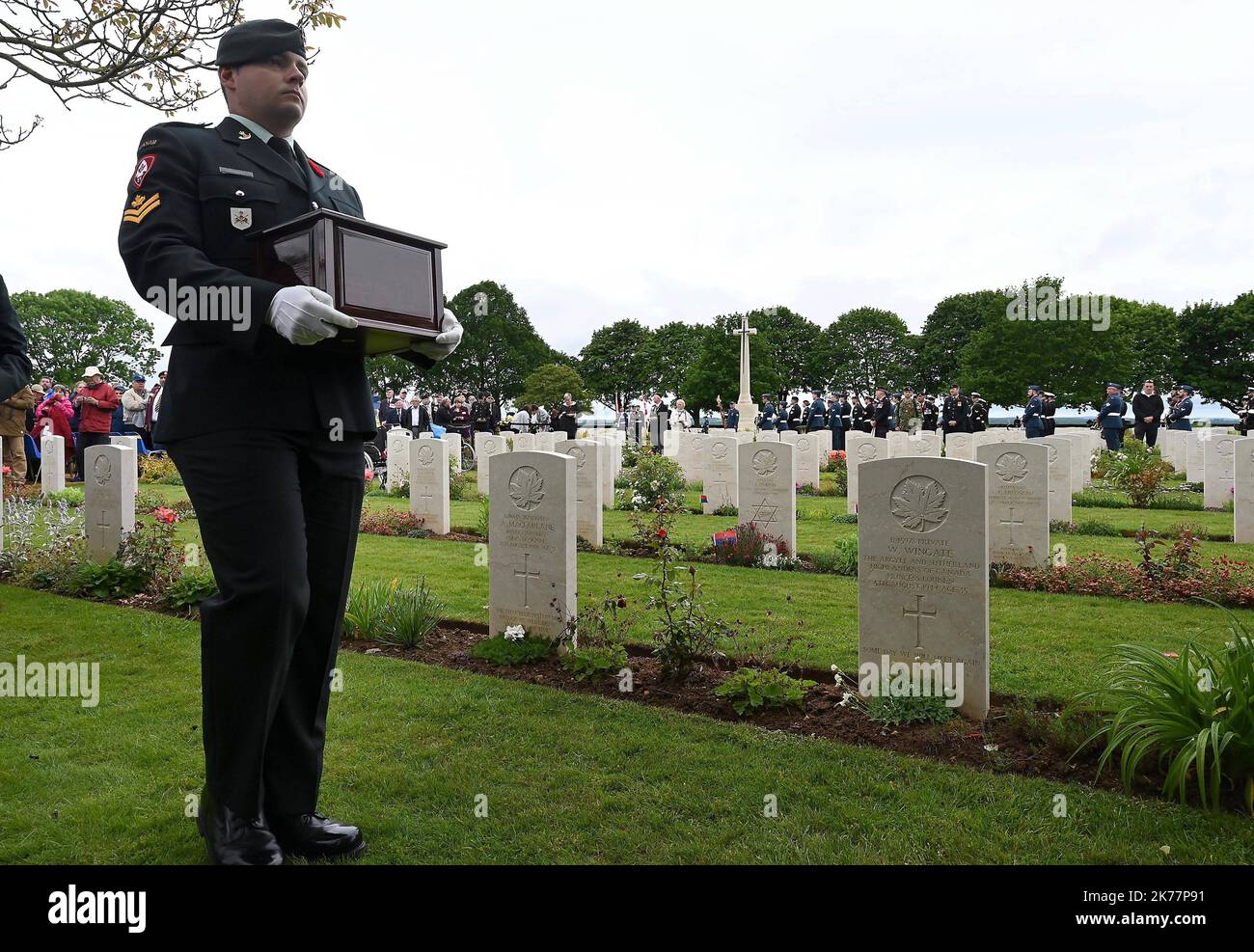 Soldiers and Veterans pay their respects during a service to mark the ...