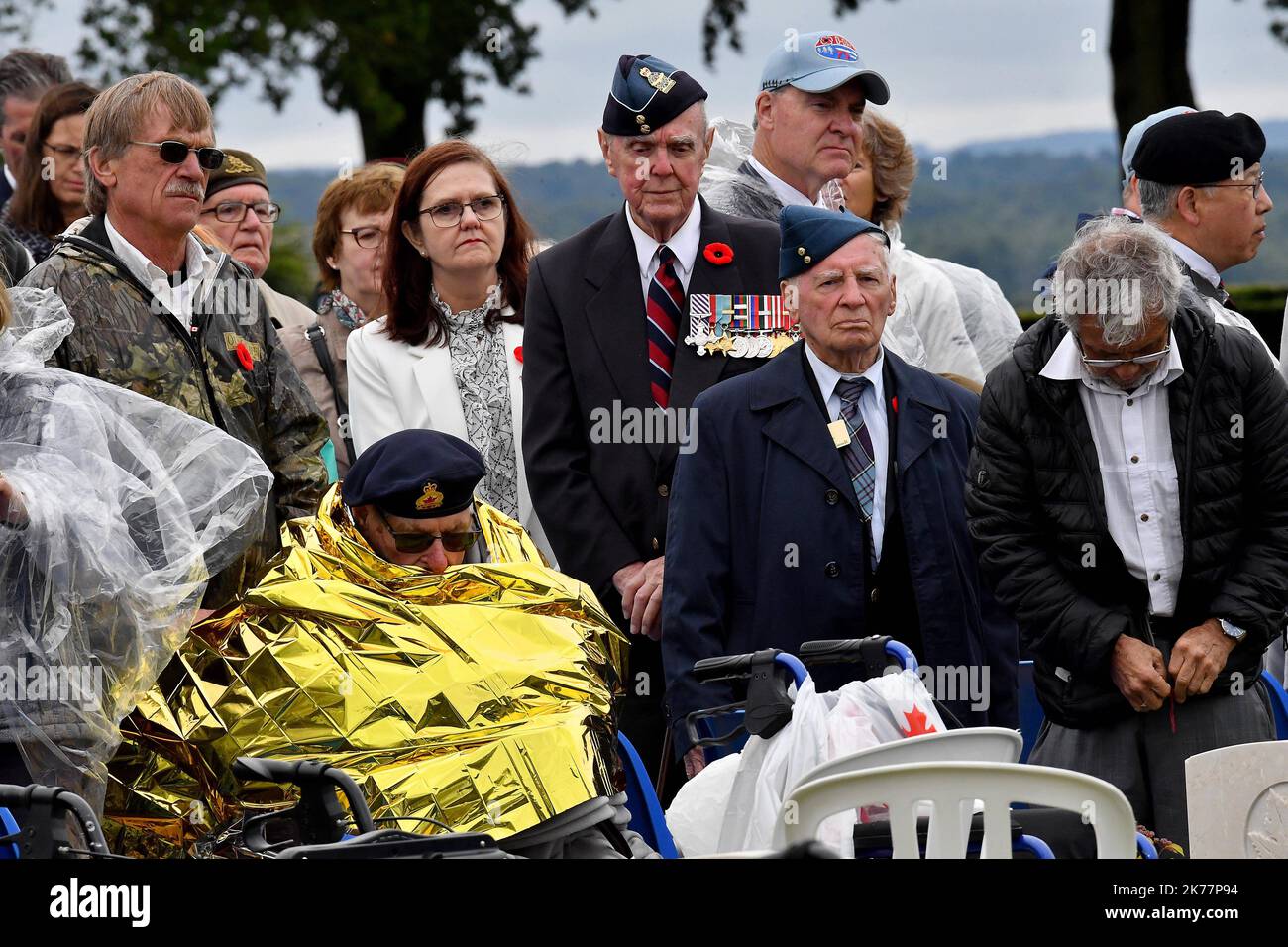Soldiers and Veterans pay their respects during a service to mark the ...