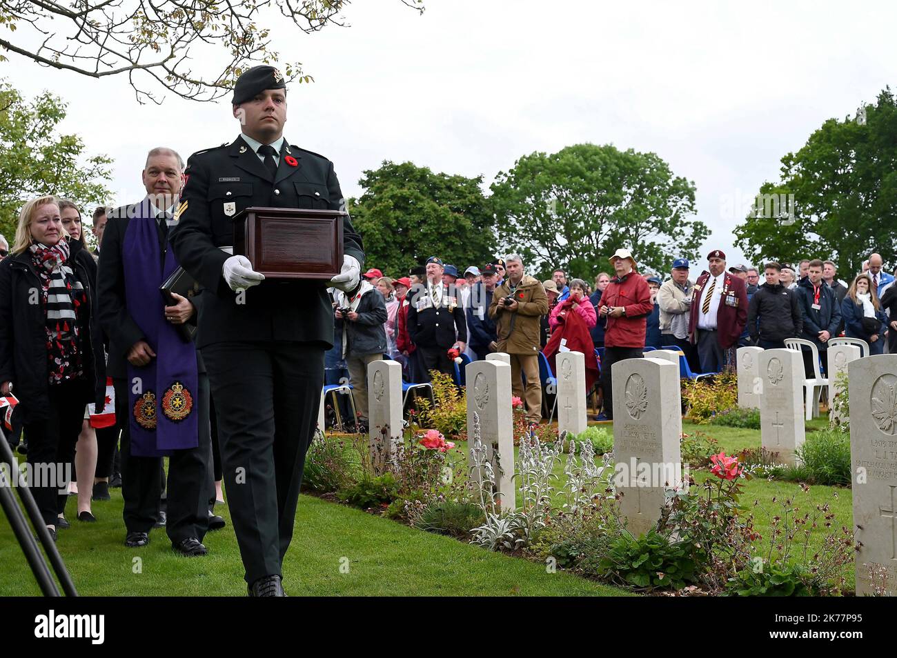 Soldiers and Veterans pay their respects during a service to mark the ...
