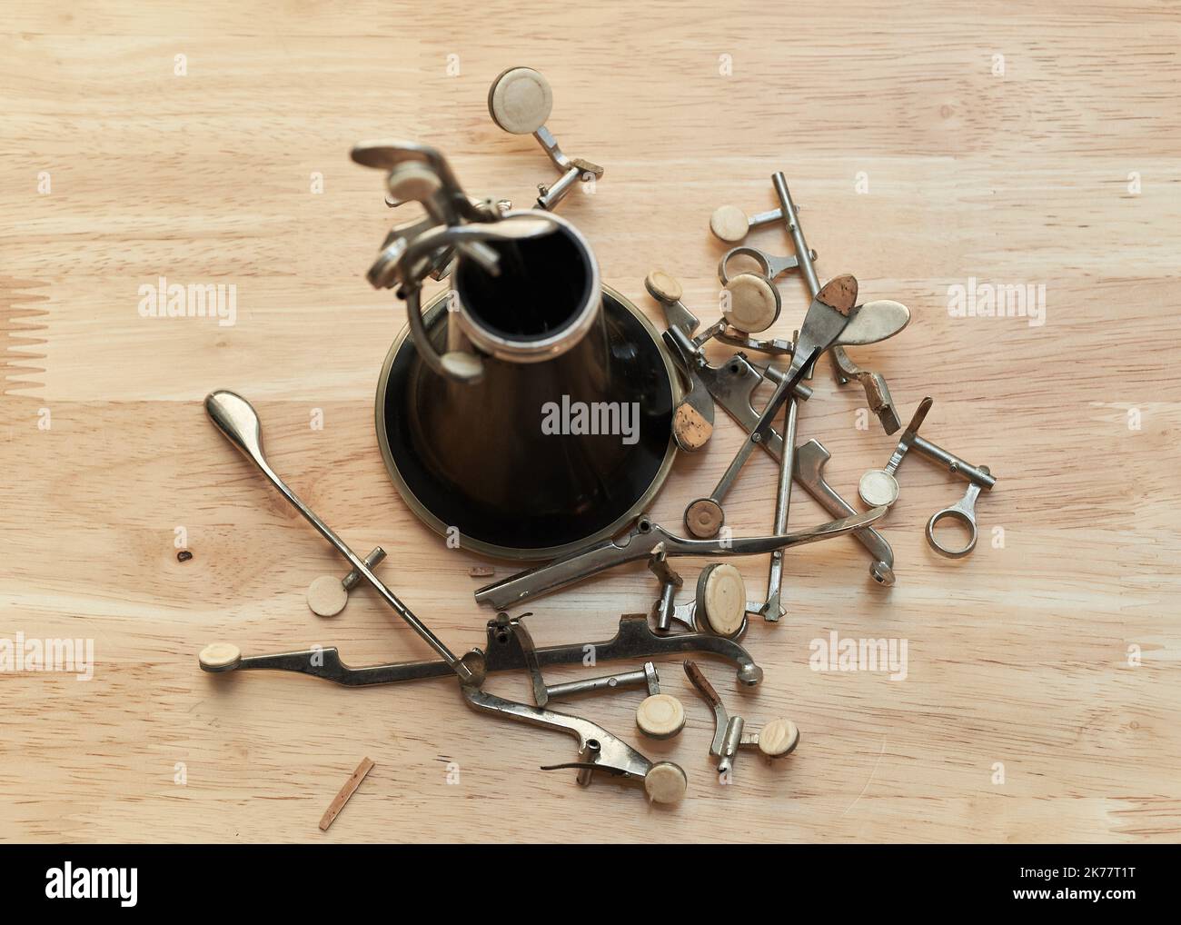 Keys, bell and other various clarinet parts are strewn around the work ...