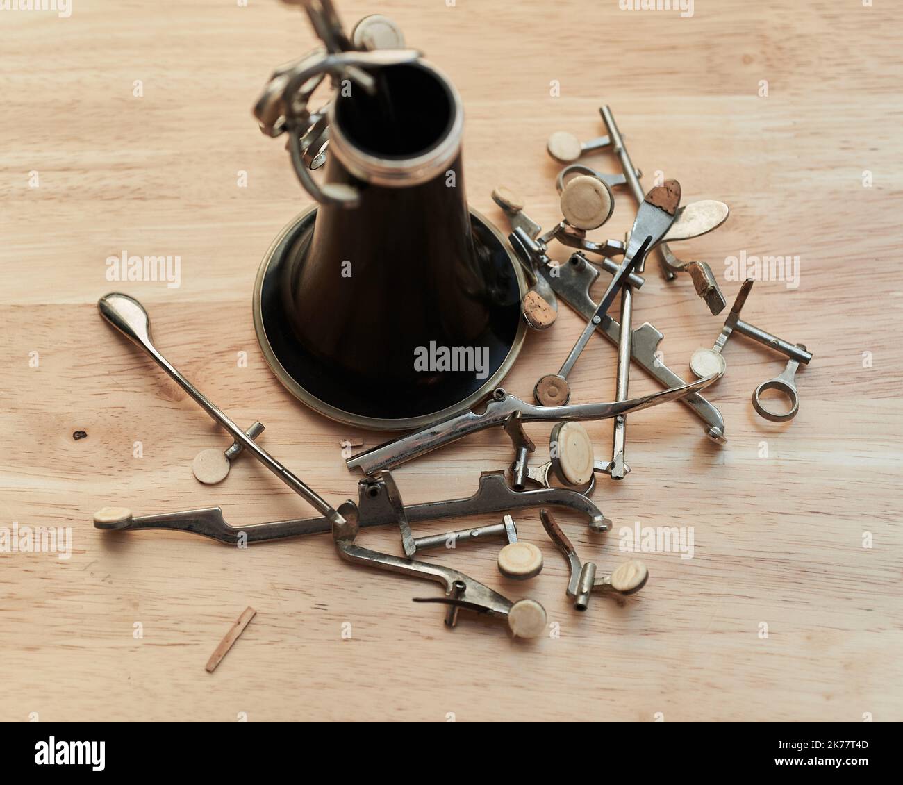 Keys, bell and other various clarinet parts are strewn around the work ...