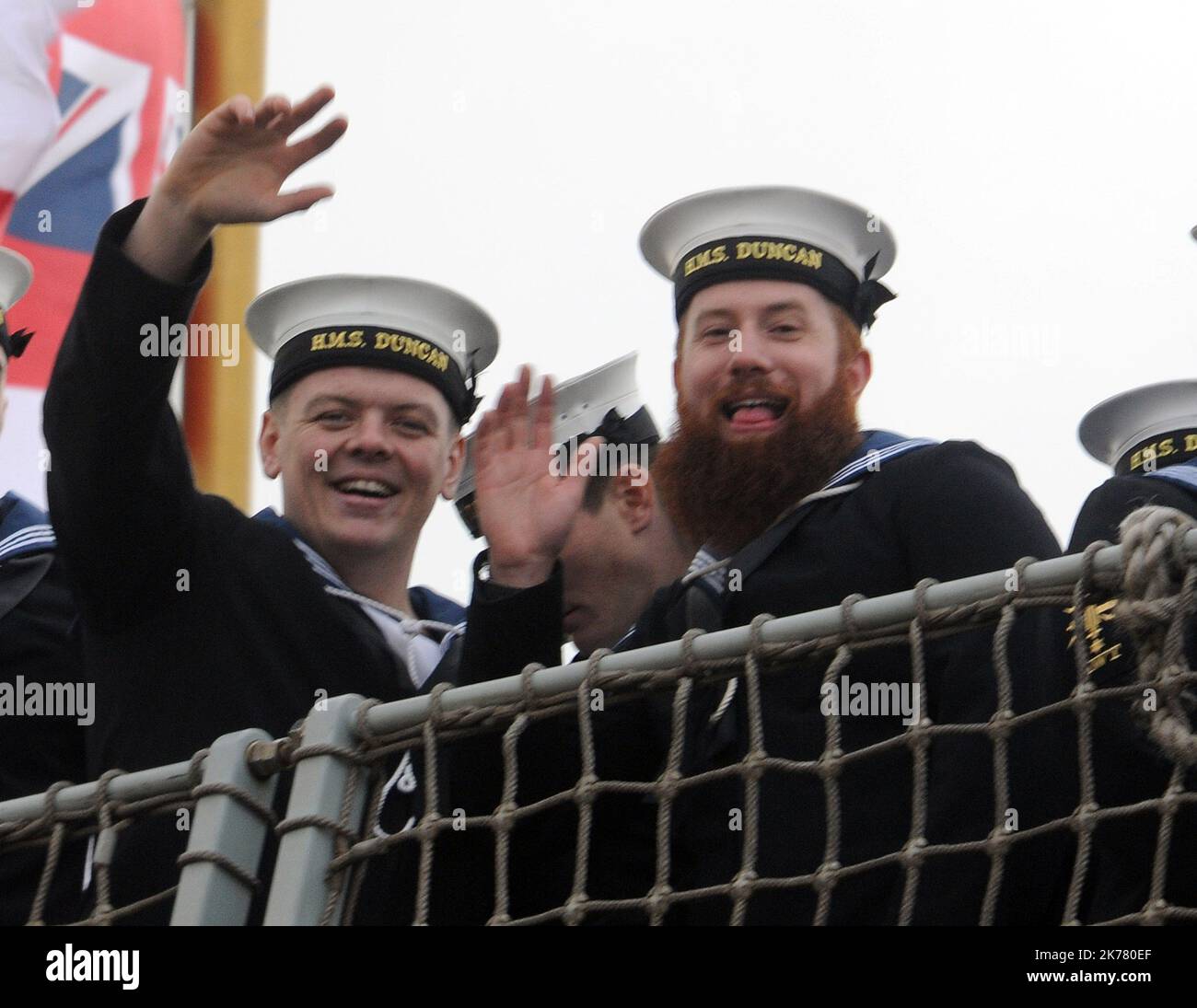 crew members wave from the deck as the Royal avy's newest warship HMS ...