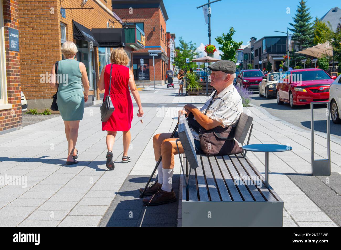 Old stylish man sitting on Rue Principale O Street in downtown Magog ...