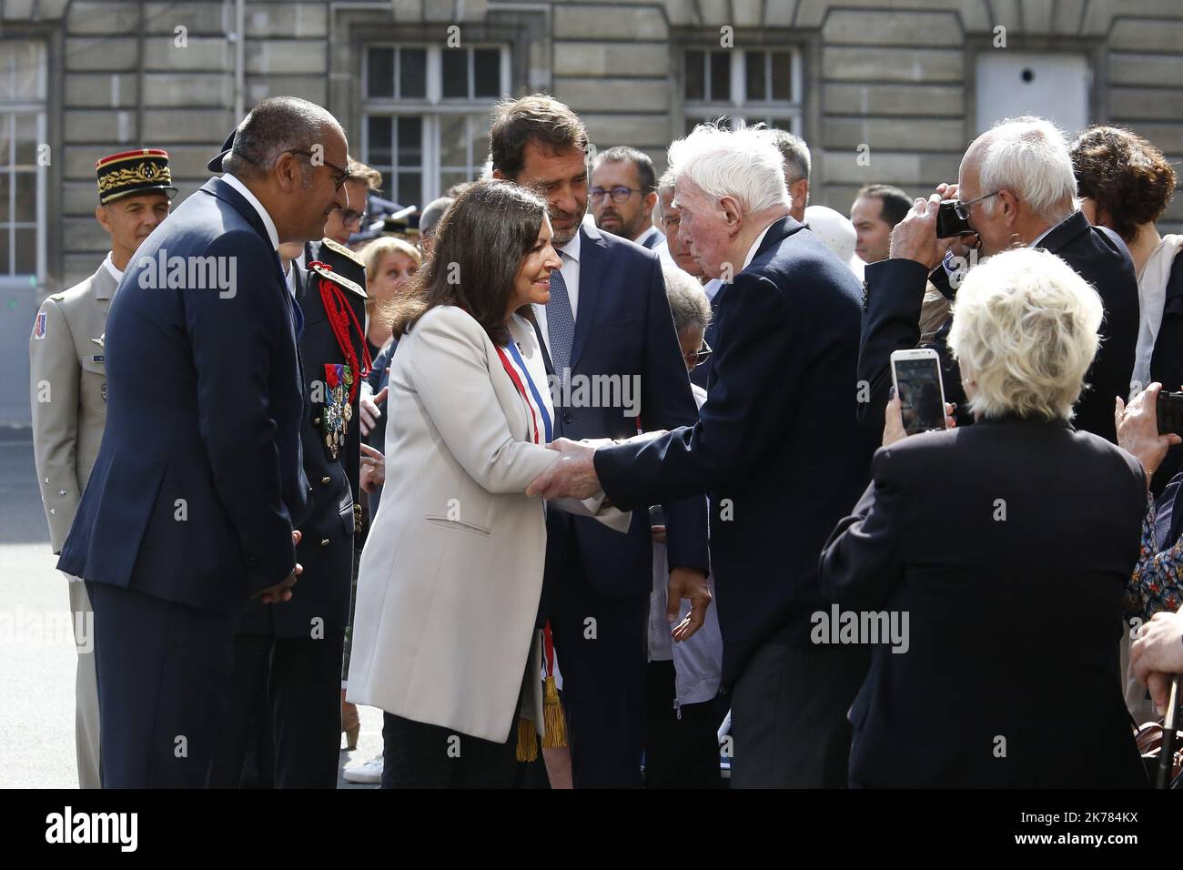 Paris' mayor Anne Hidalgo greets French veteran Robert Pincon as French ...