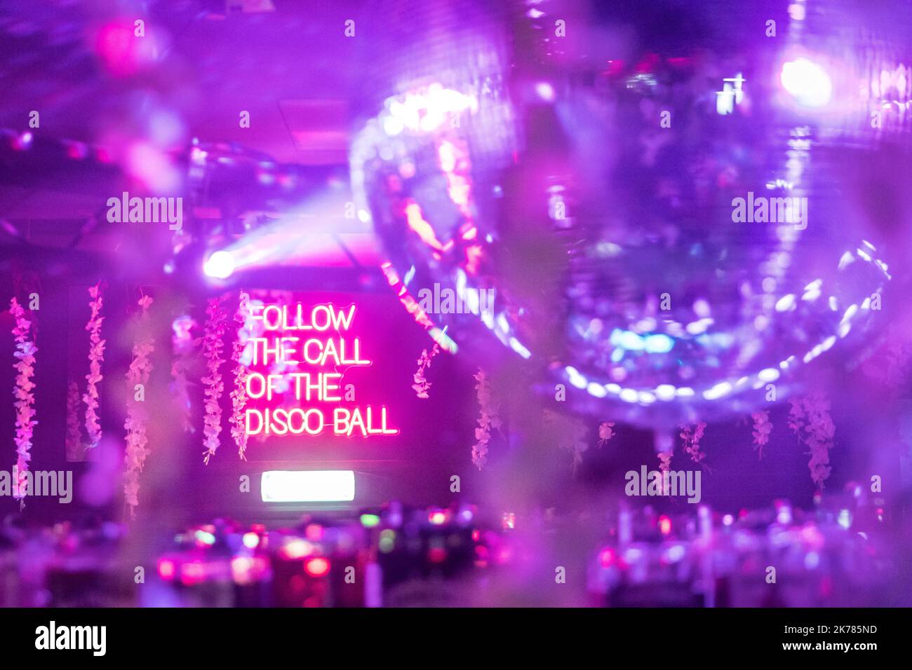 Glitter ball with neon sign Stock Photo - Alamy