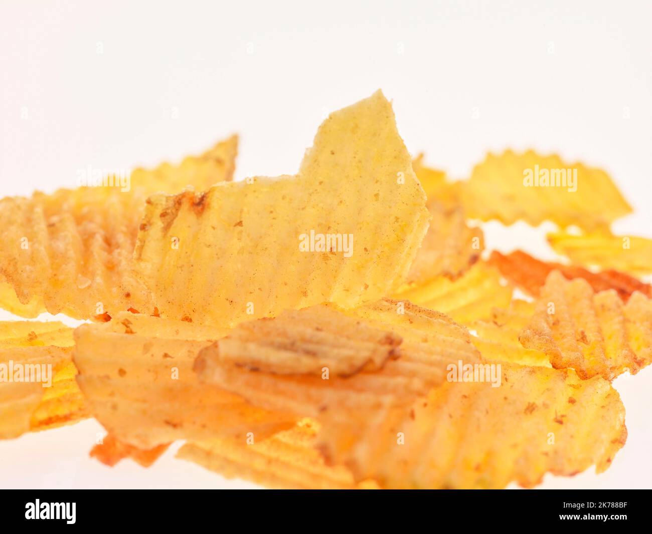 Clean background crinkle cut potato crisps in close up, food snack ...