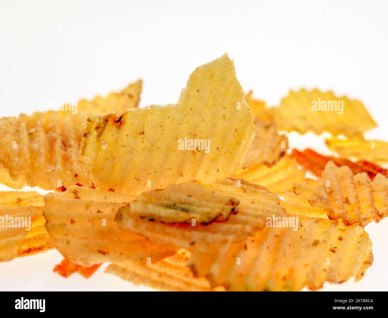 Clean background crinkle cut potato crisps in close up, food snack ...