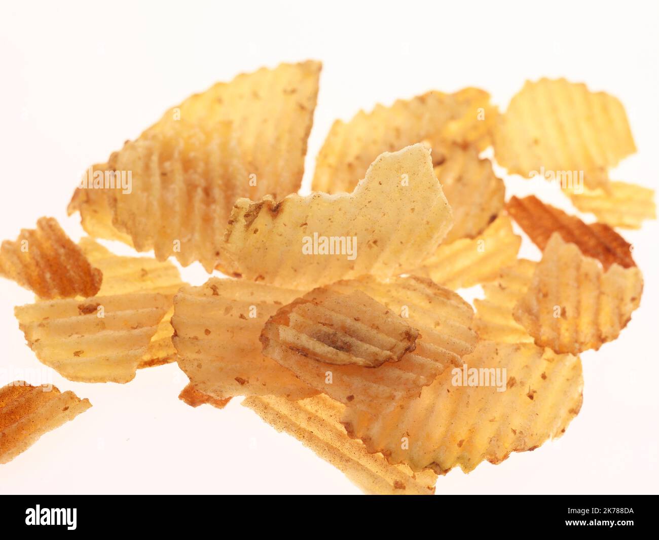 Clean background crinkle cut potato crisps in close up, food snack ...