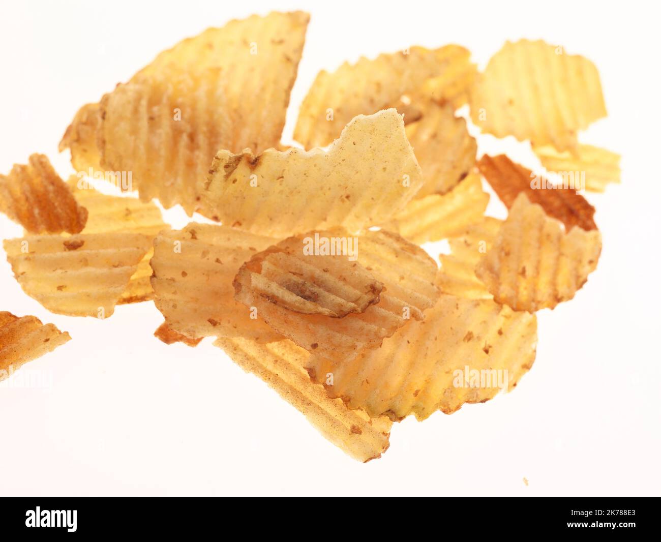Clean background crinkle cut potato crisps in close up, food snack ...