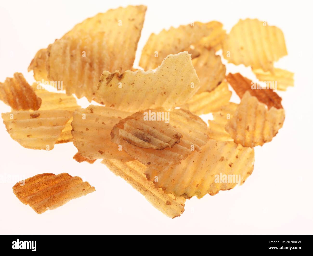Clean background crinkle cut potato crisps in close up, food snack ...