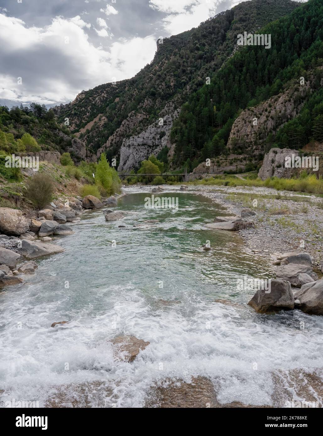 aqua blue clear mountain river water flowing through a stone gorge ...