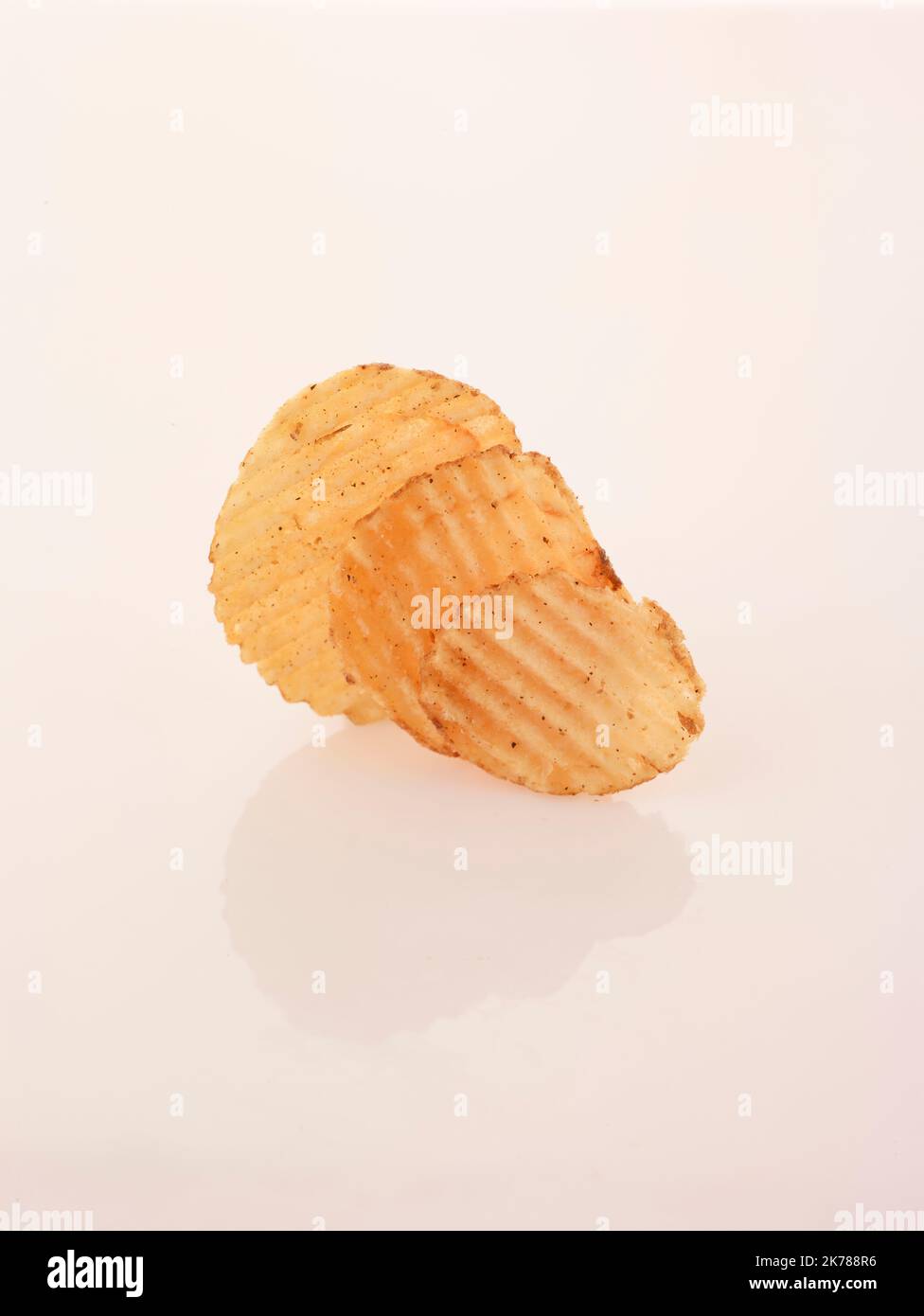 Clean background crinkle cut potato crisps in close up, food snack ...
