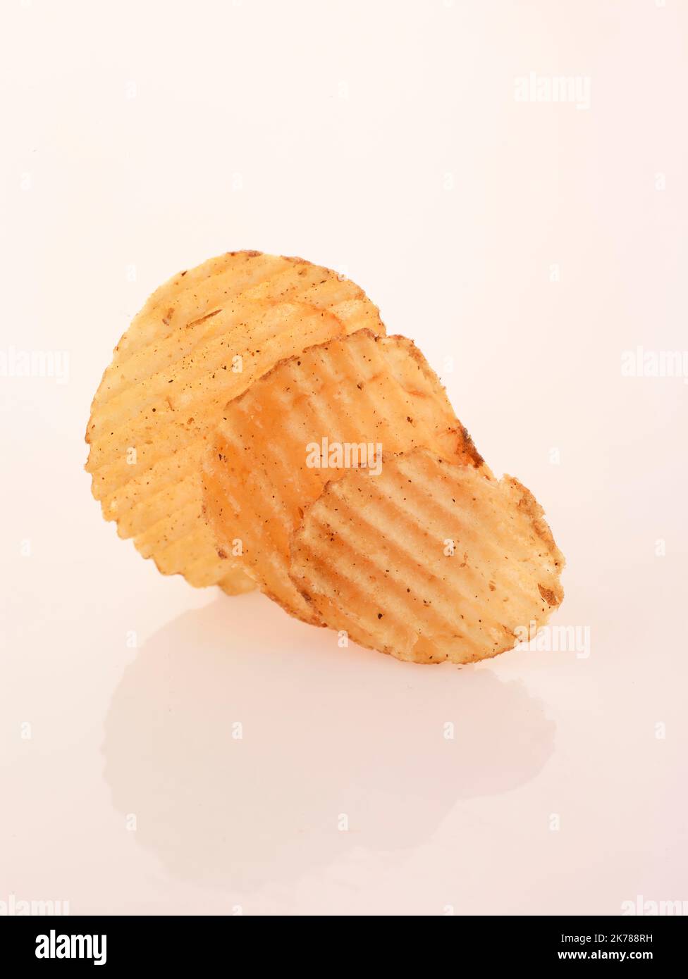 Clean background crinkle cut potato crisps in close up, food snack ...