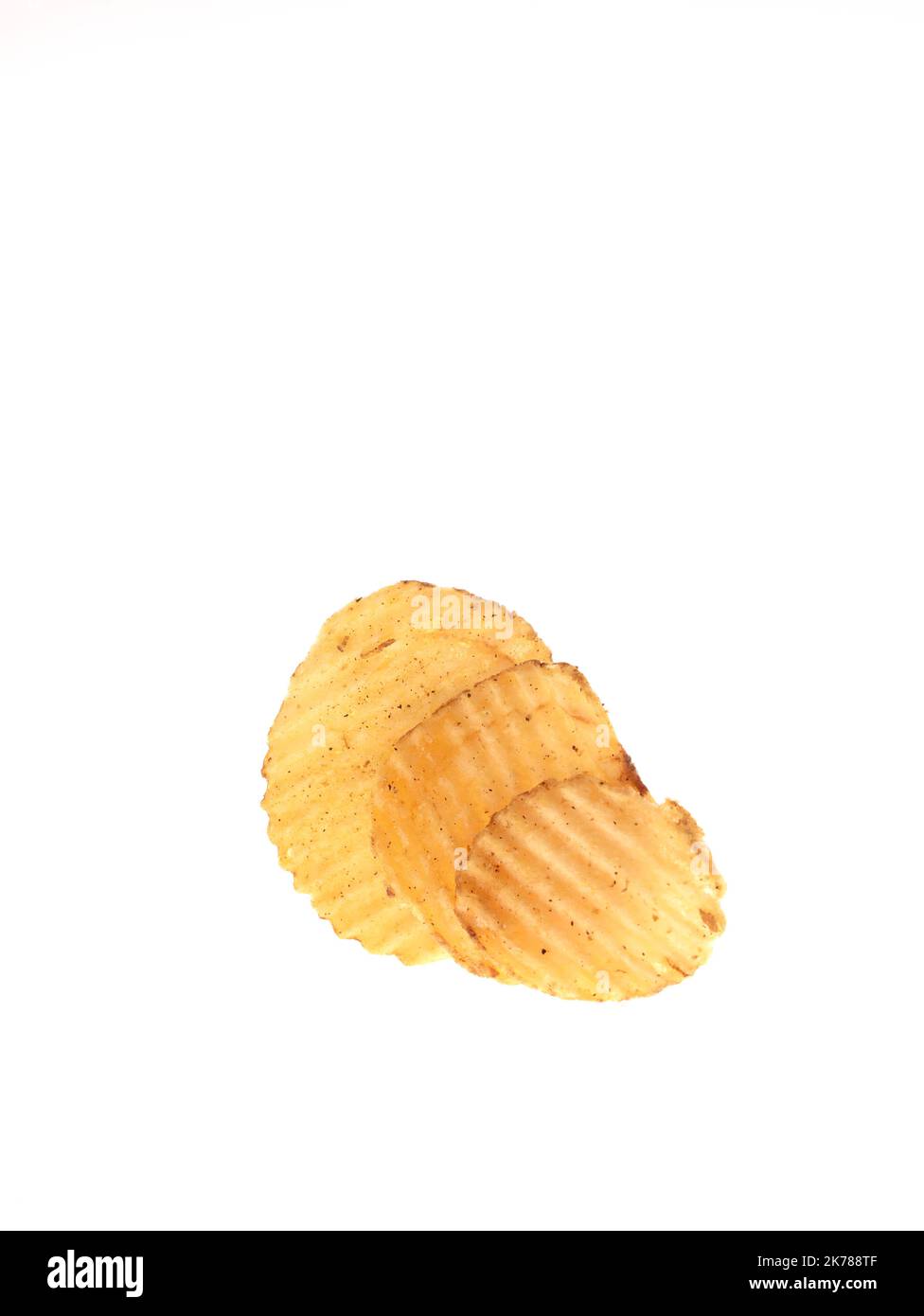 Clean background crinkle cut potato crisps in close up, food snack ...