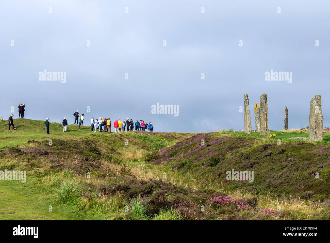 Tourist looking the Ring of Brodgar, Neolithic henge and stone circle ...