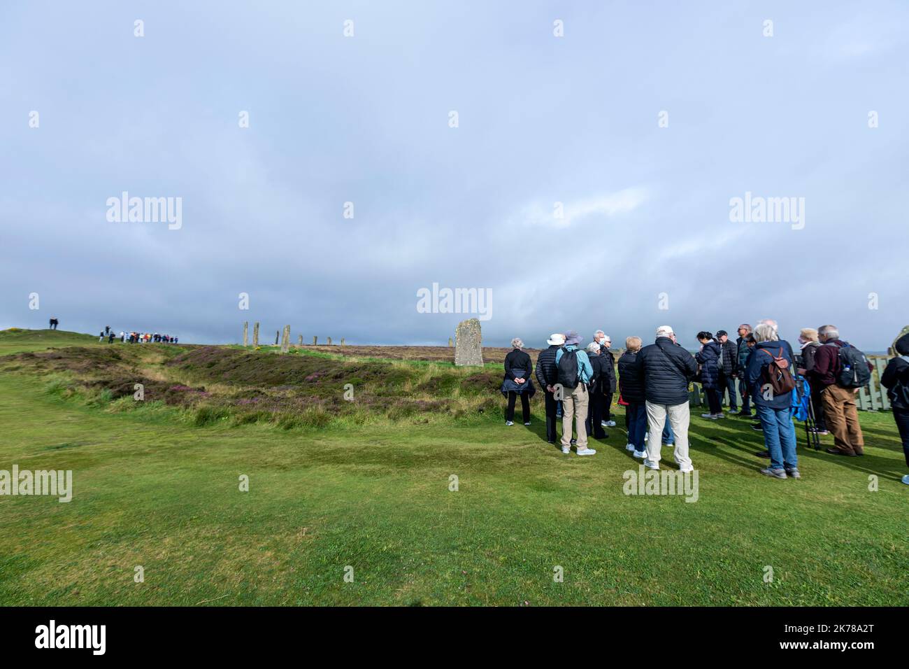 Tourist looking the Ring of Brodgar, Neolithic henge and stone circle ...