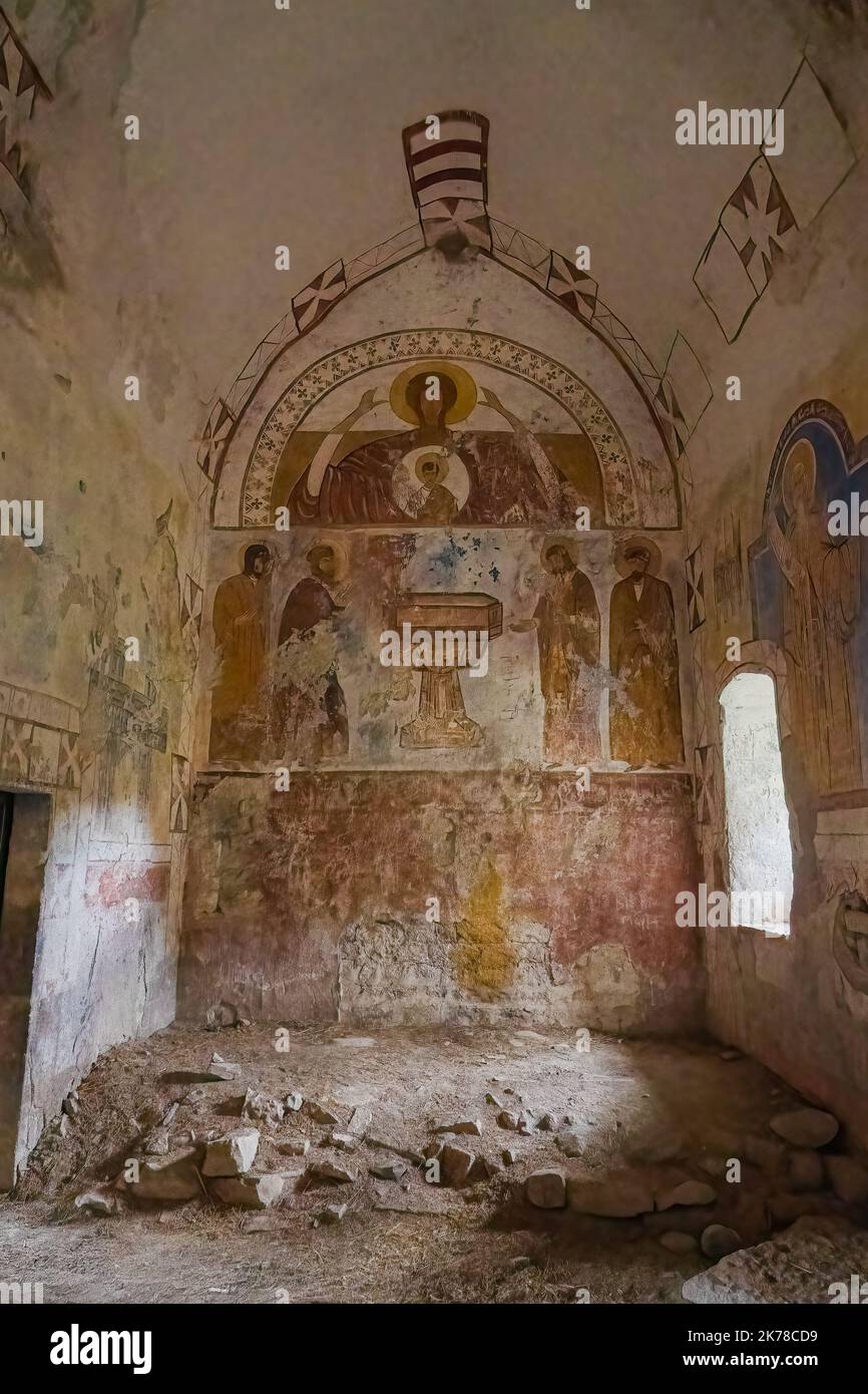 murals and wall paintings inside an old partly ruined church in a ...