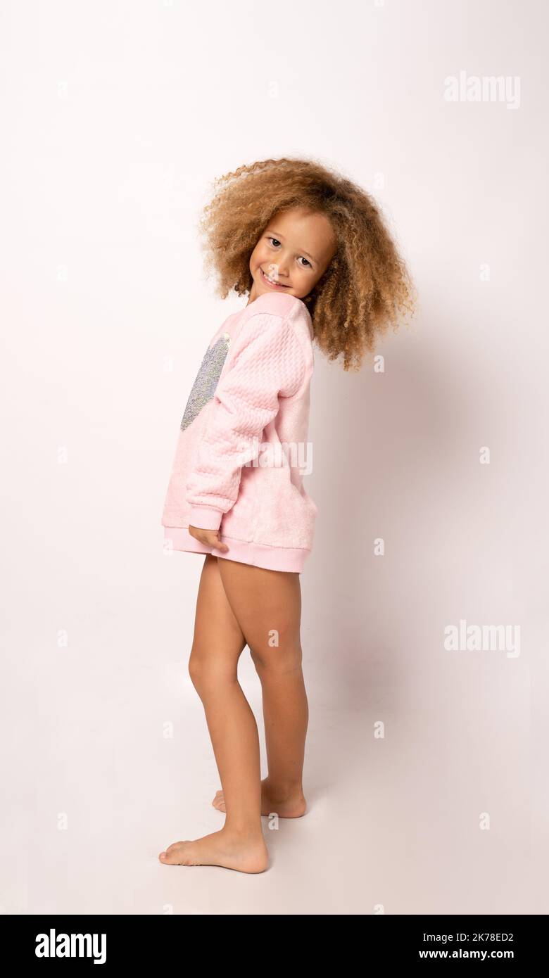 Full length body size view of cheerful skinny child girl with curly ...