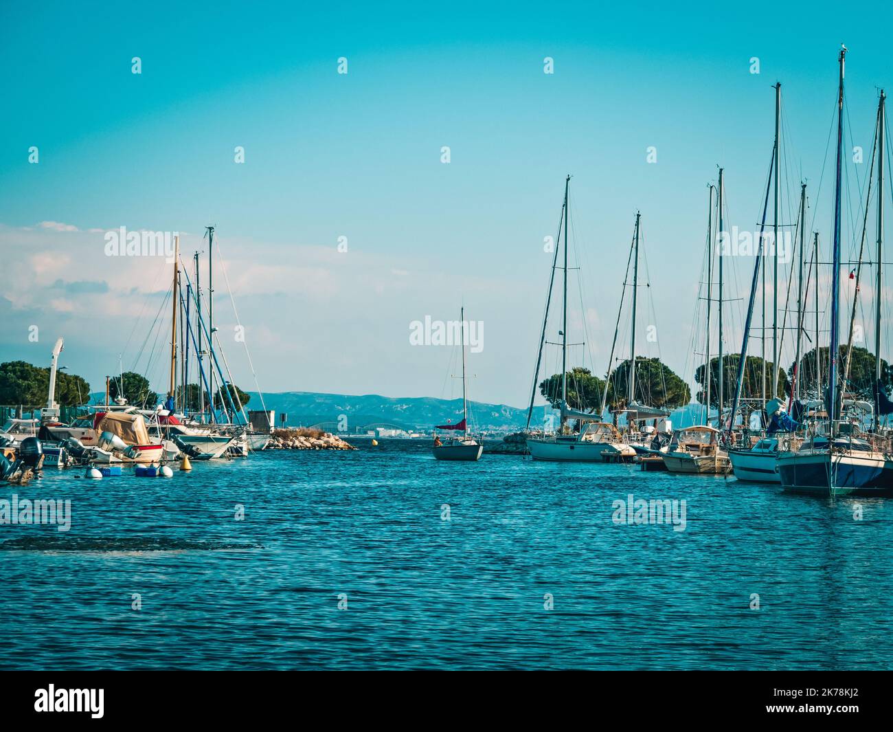 Boat entering the port of Albert Samson Stock Photo - Alamy