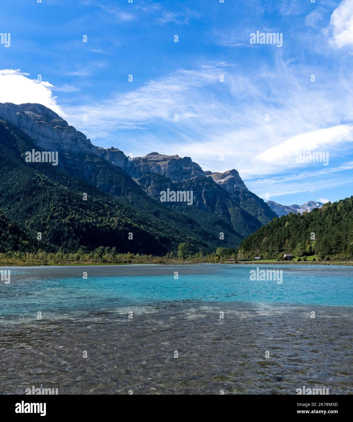man-made aqua blue water reservoir to feed a mountain hydro power ...