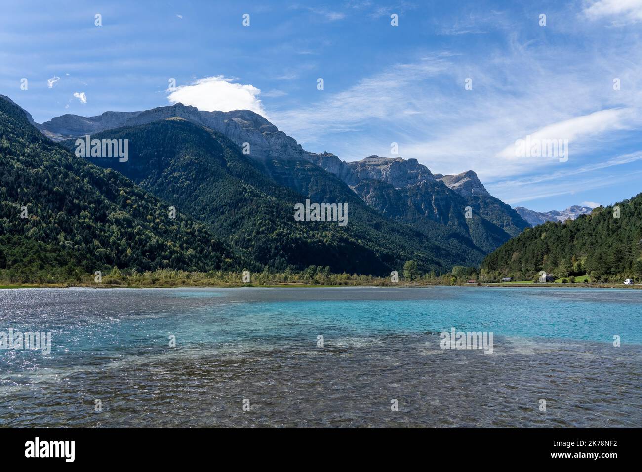 man-made aqua blue water reservoir to feed a mountain hydro power ...